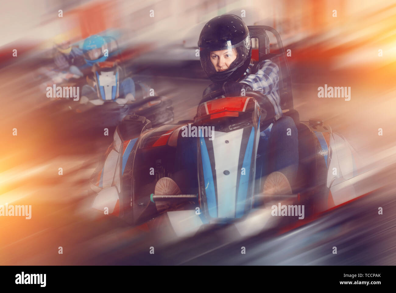 Portrait of female racer in helmet driving a kart on the track Stock ...