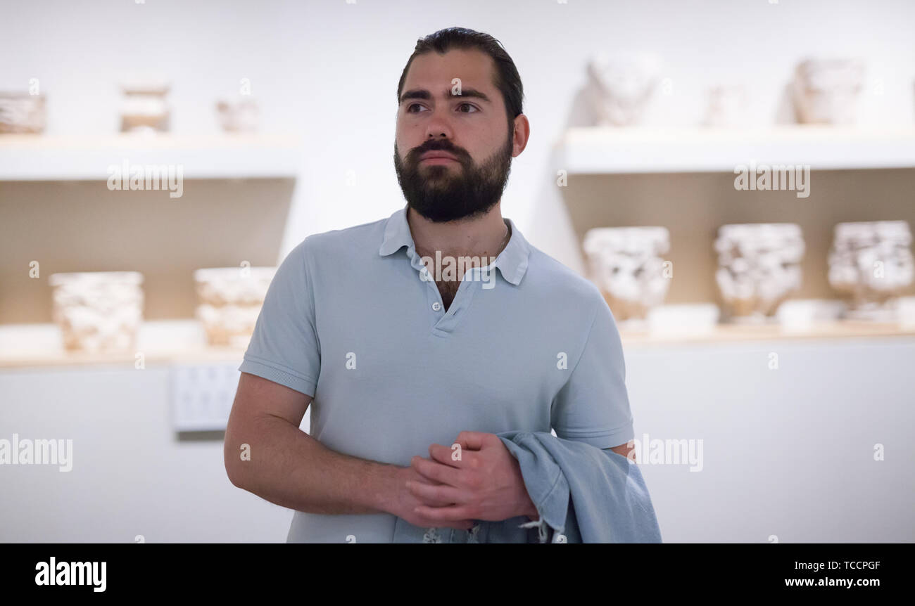 Man visiting sculpture hall in historical museum and looking at ...