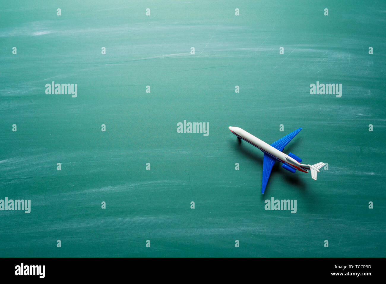 toy airplane over chalkboard background Stock Photo - Alamy