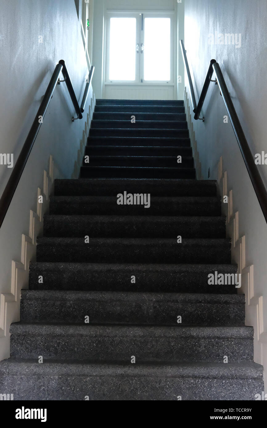 stairs stairway staircase leading up to window light Stock Photo - Alamy