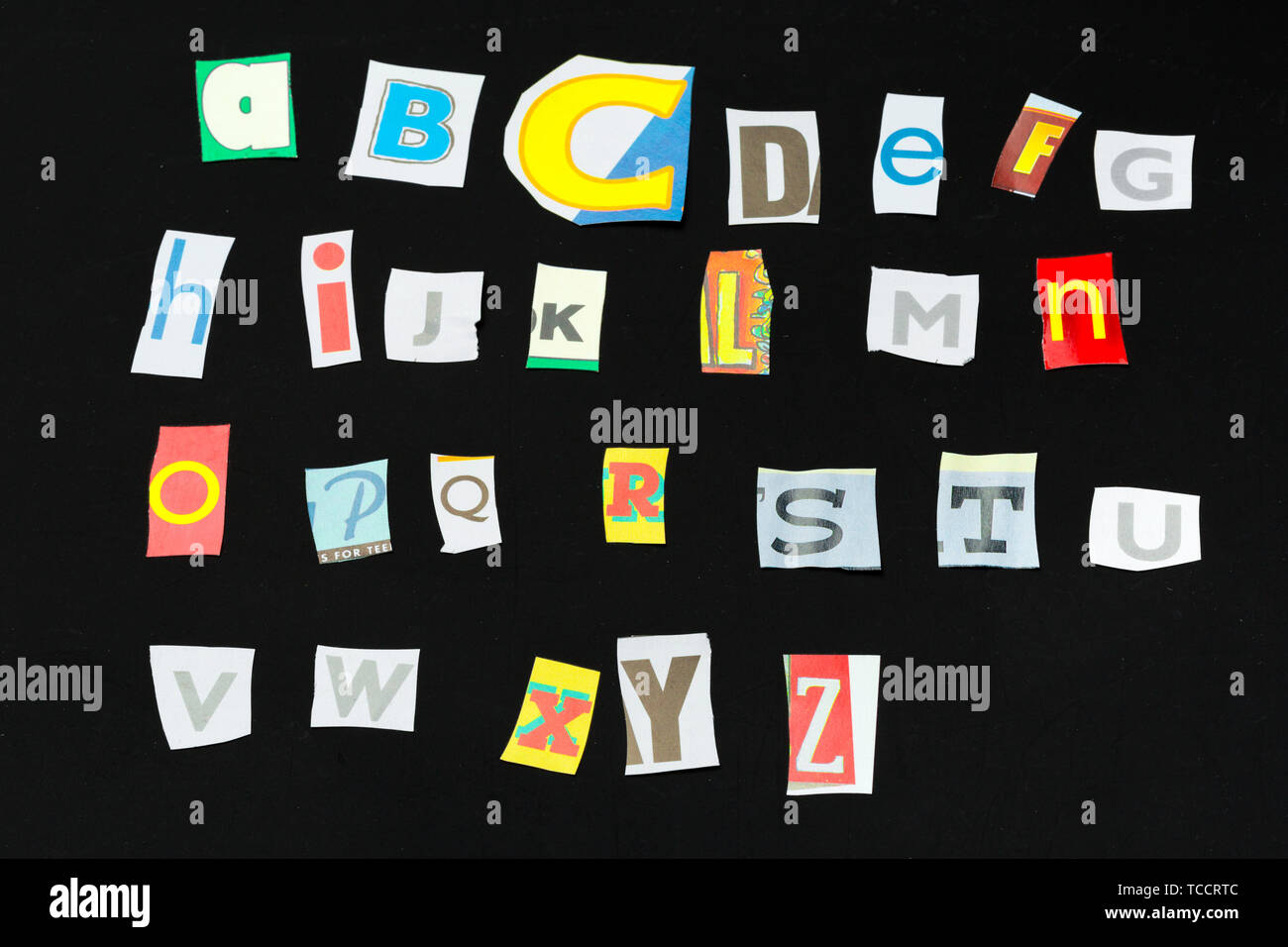 Colorful newspaper alphabet isolated on black Stock Photo - Alamy