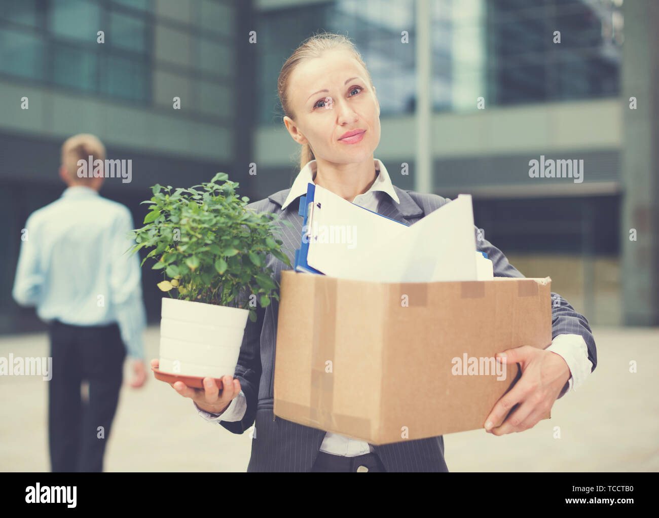 Businesswoman is standing happy near office because she leave bad job ...