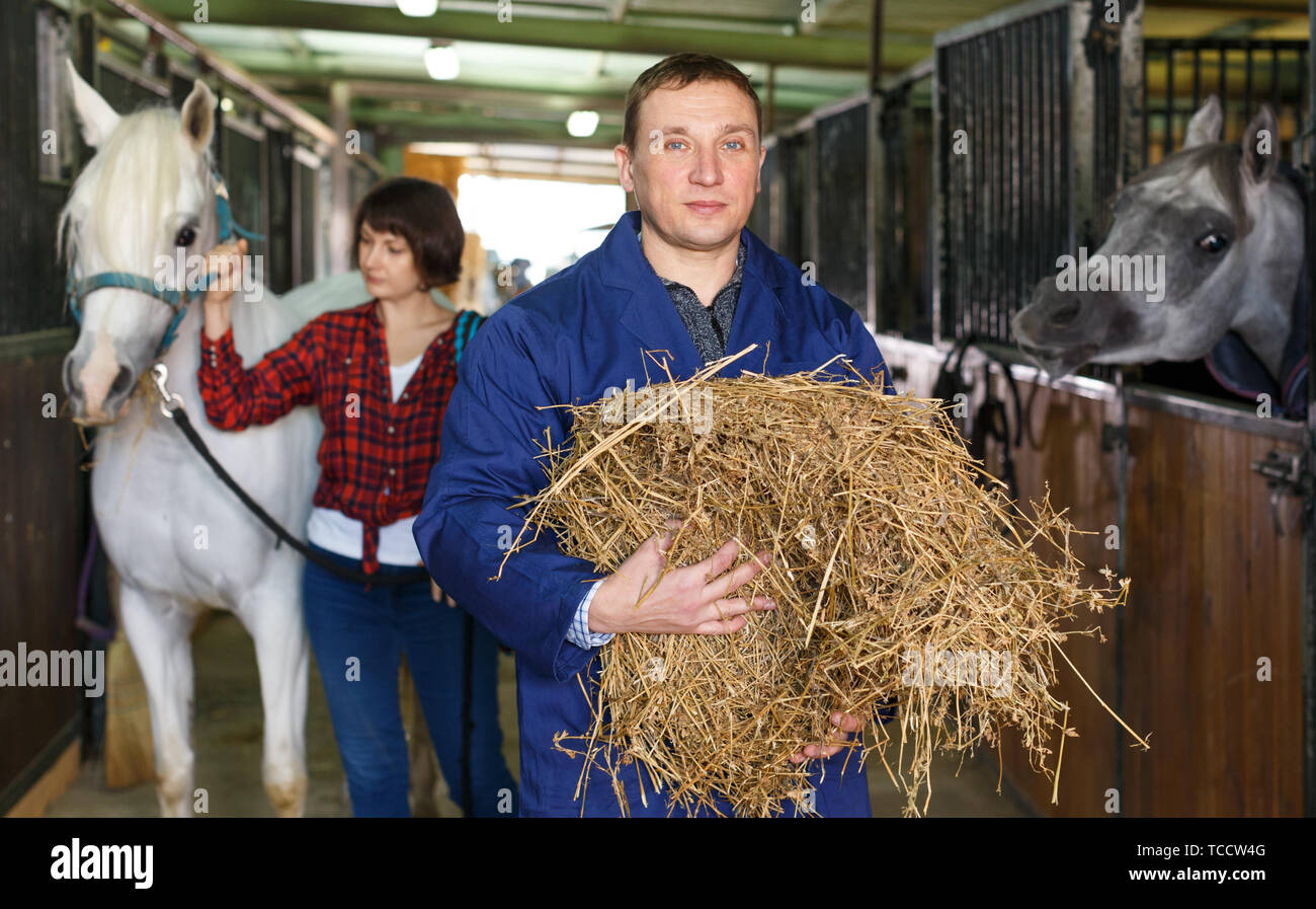 Couple working in stable hi-res stock photography and images - Alamy