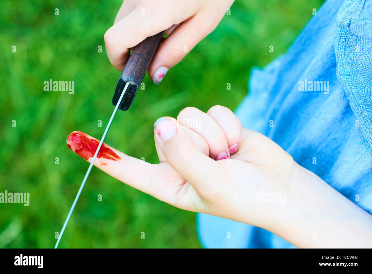 Accident wounded on finger with blood and knife. Child playing with ...