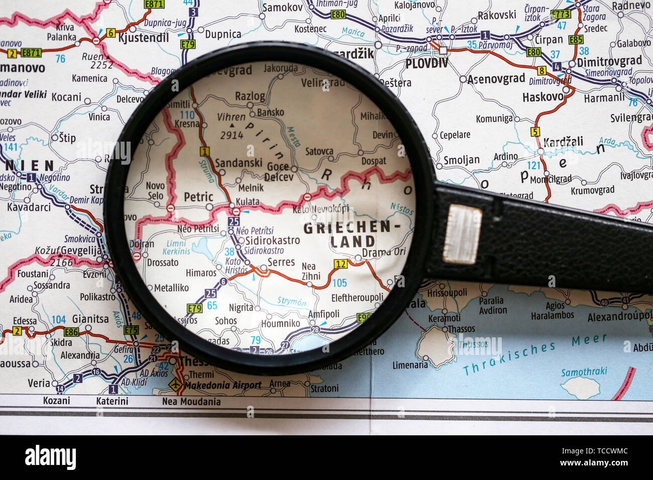 Greece on the map and magnifying glass Stock Photo - Alamy