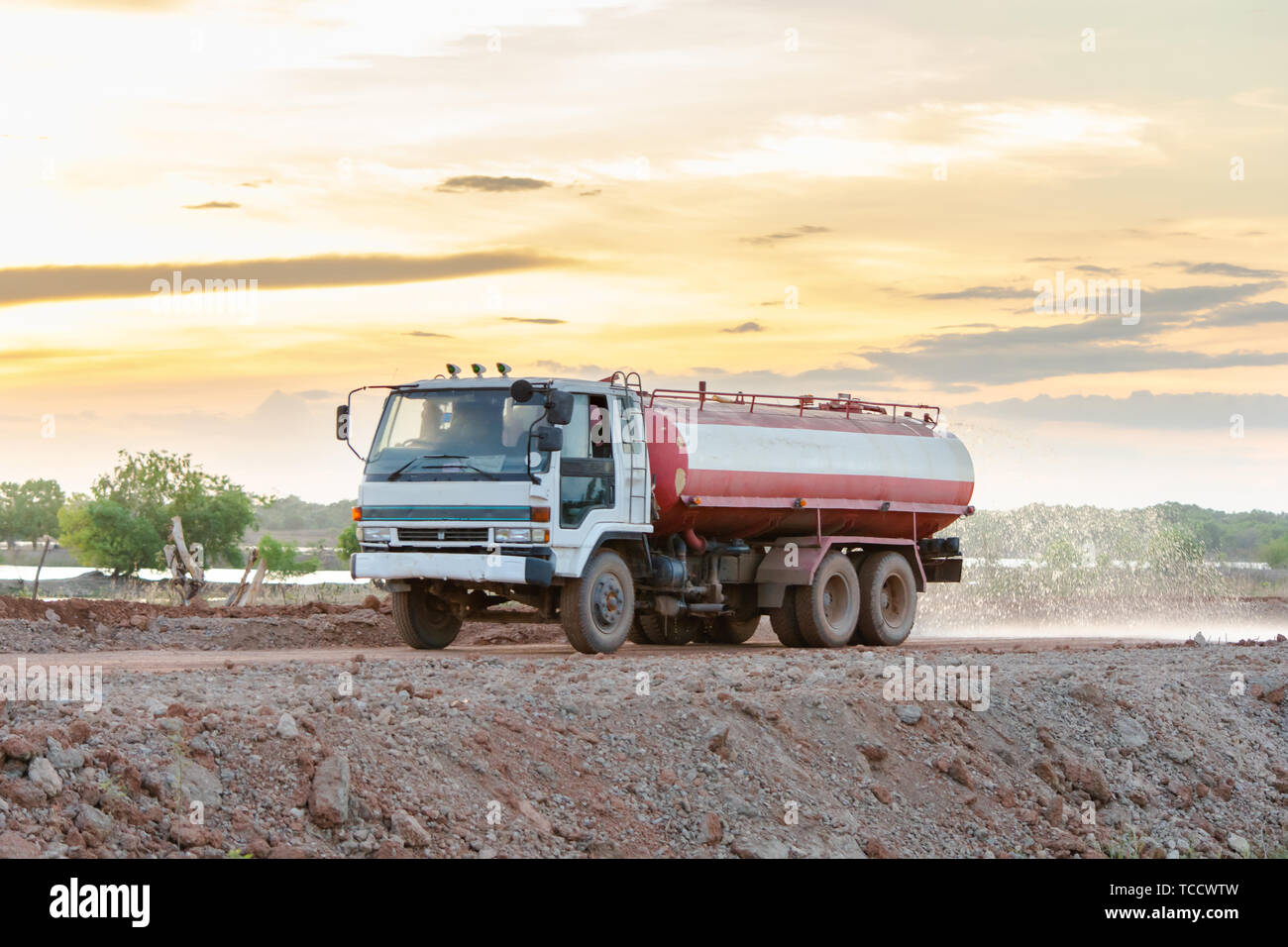 Water truck sprays water for a new road construction site Stock Photo ...