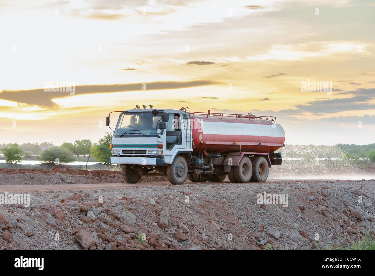 Water truck sprays water for a new road construction site Stock Photo ...