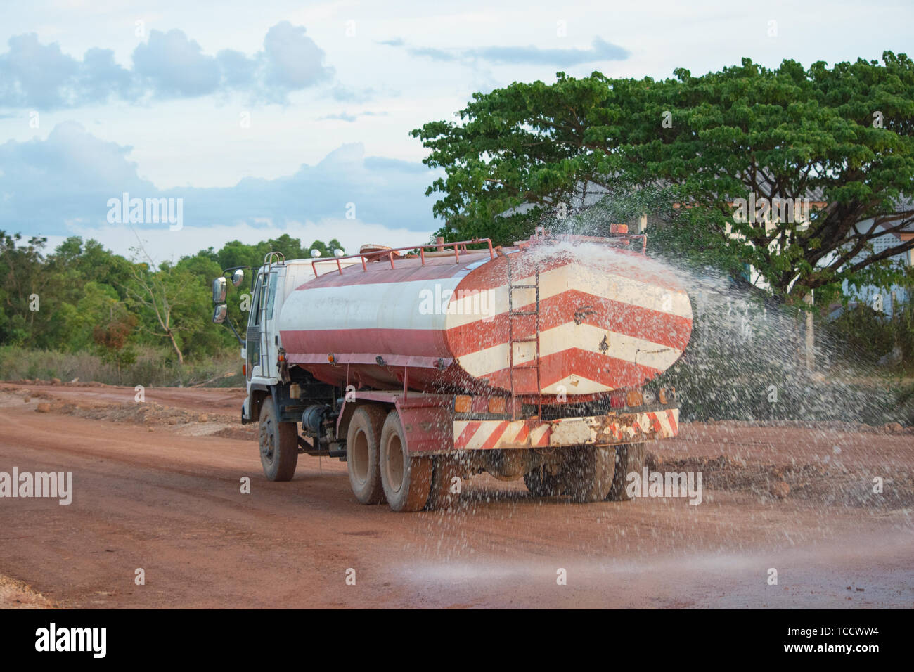 Water truck sprays water for a new road construction site Stock Photo ...