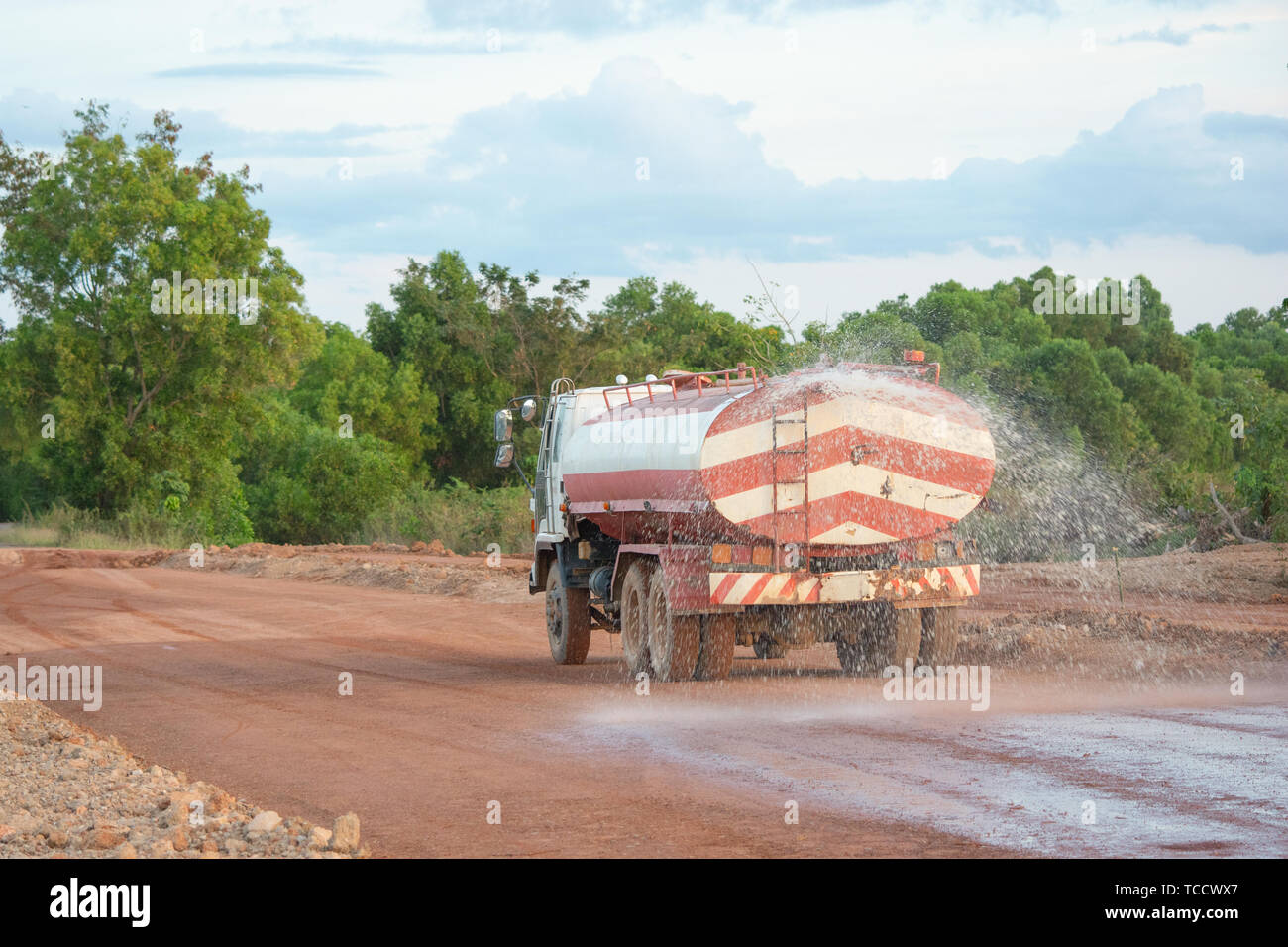 Water truck sprays water for a new road construction site Stock Photo ...