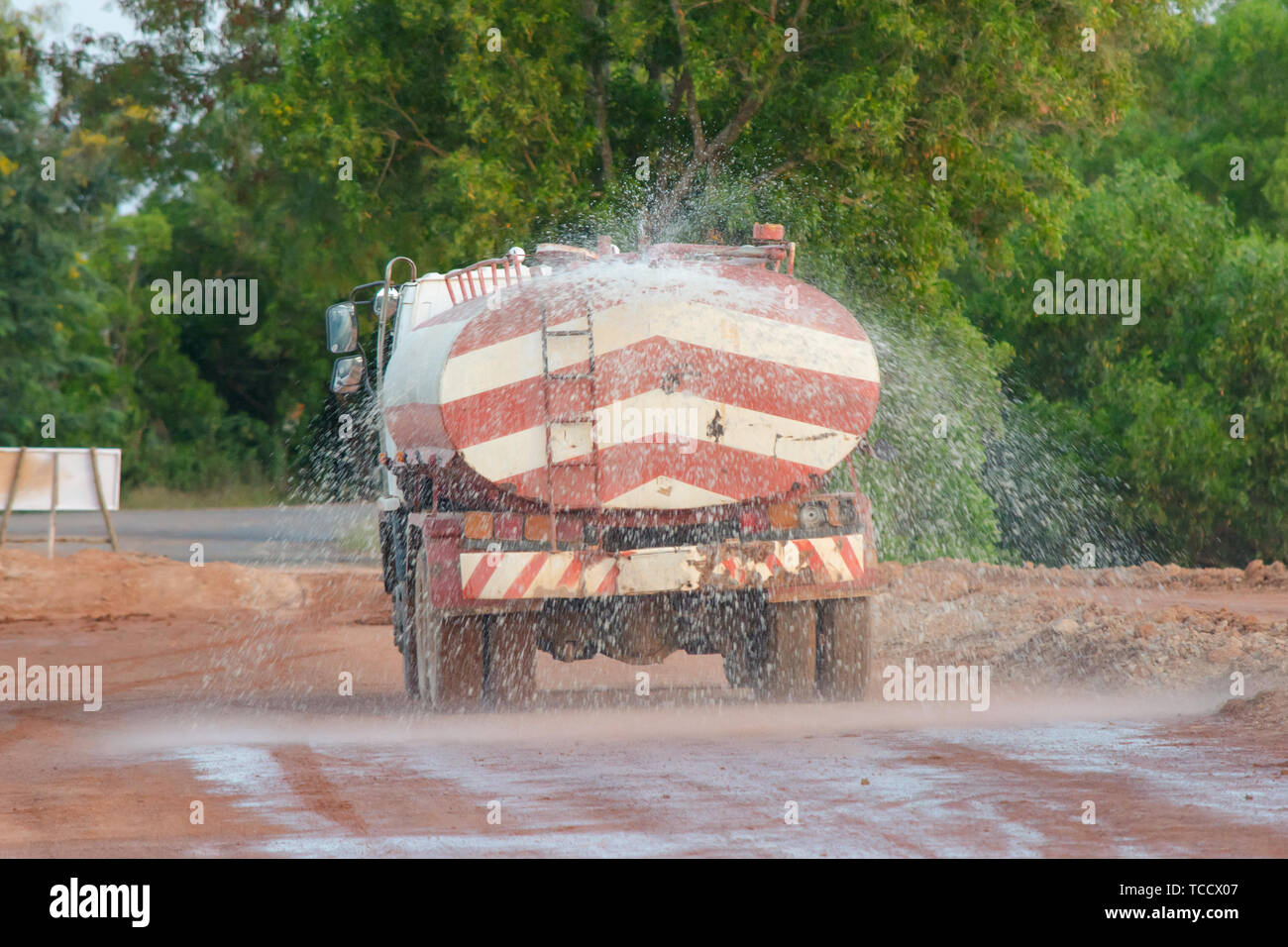 Water truck sprays water for a new road construction site Stock Photo ...