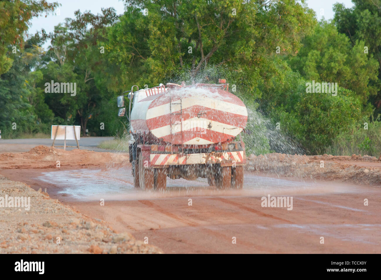 Water truck sprays water for a new road construction site Stock Photo ...