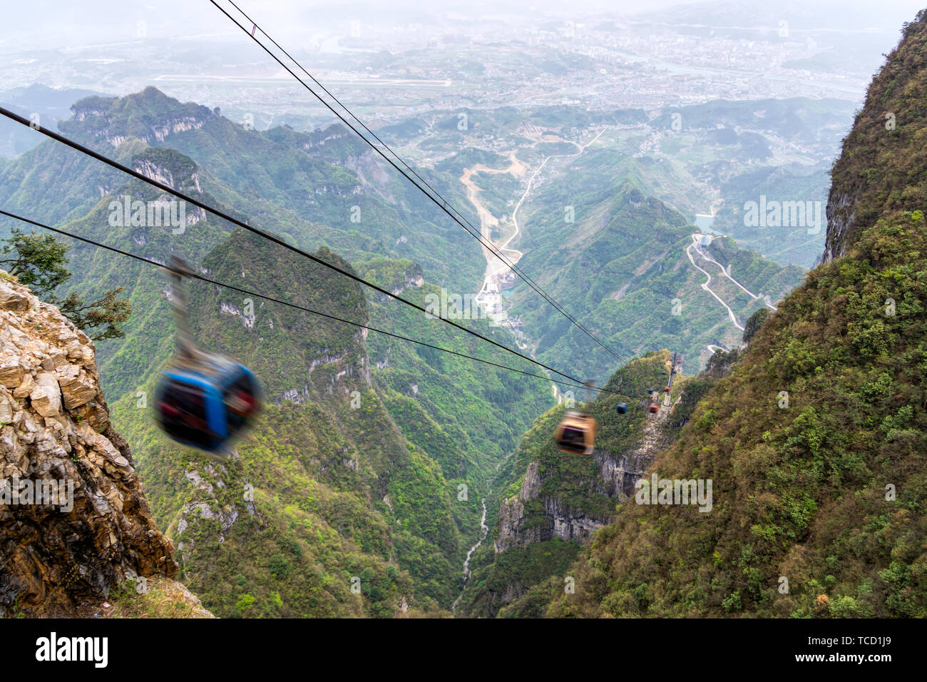 Cable way cart in motion blur, cables and carts vanishing in the depth ...