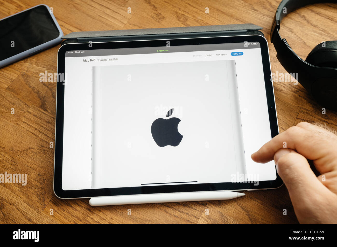 Paris, France - Jun 6, 2019: Man reading on Apple iPad Pro tablet about ...
