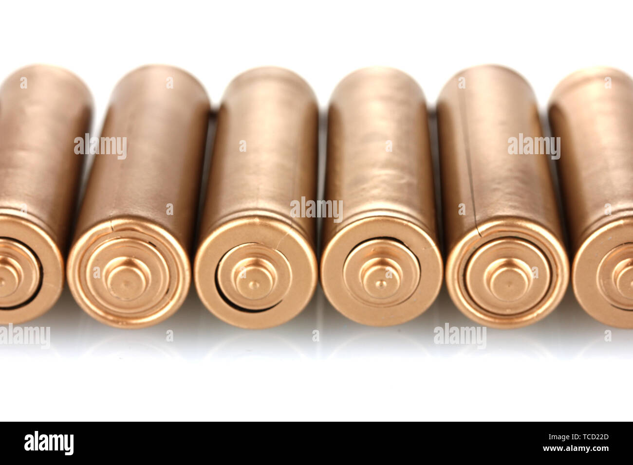 golden batteries isolated on white Stock Photo - Alamy