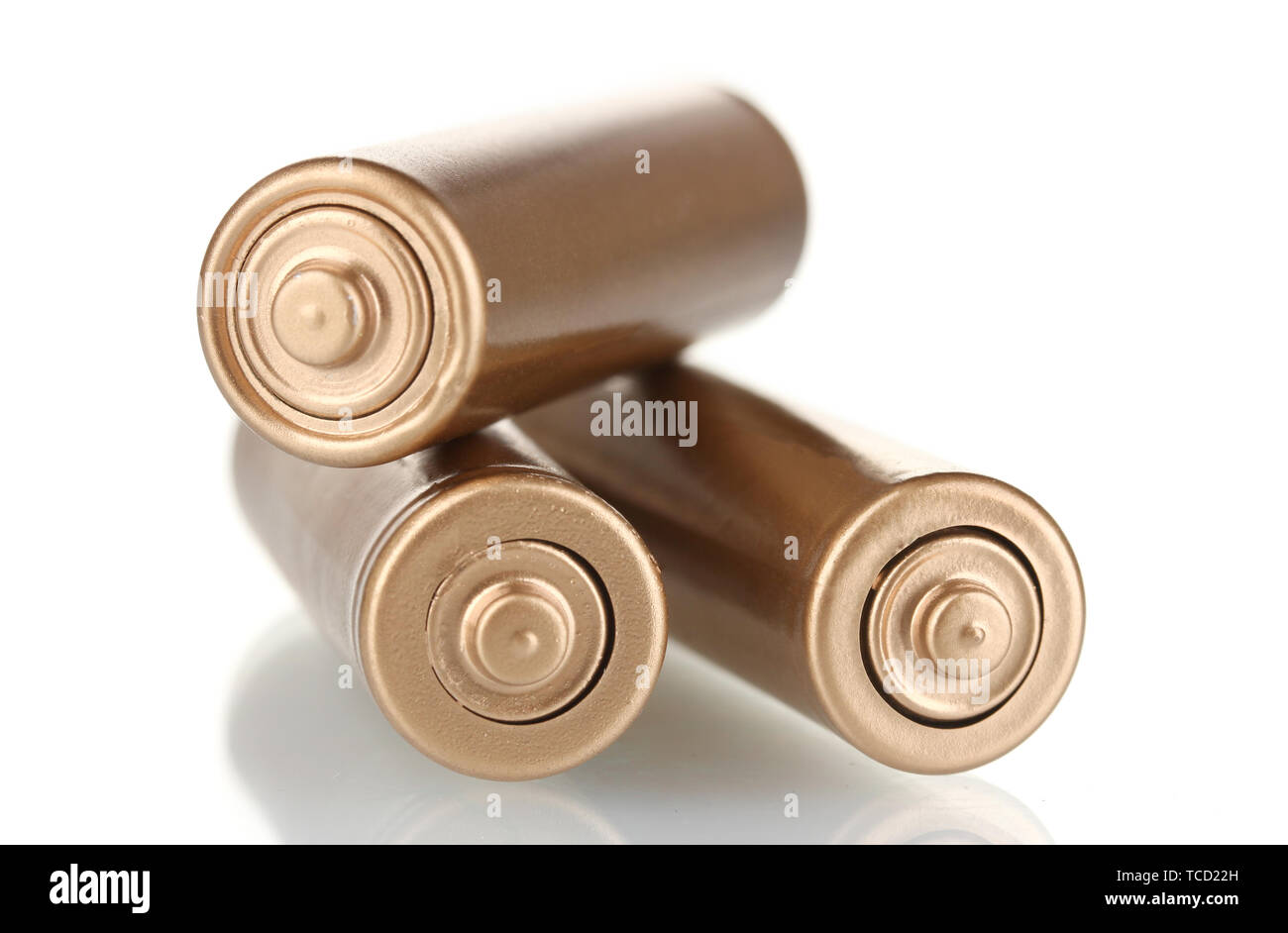 three golden batteries isolated on white Stock Photo - Alamy