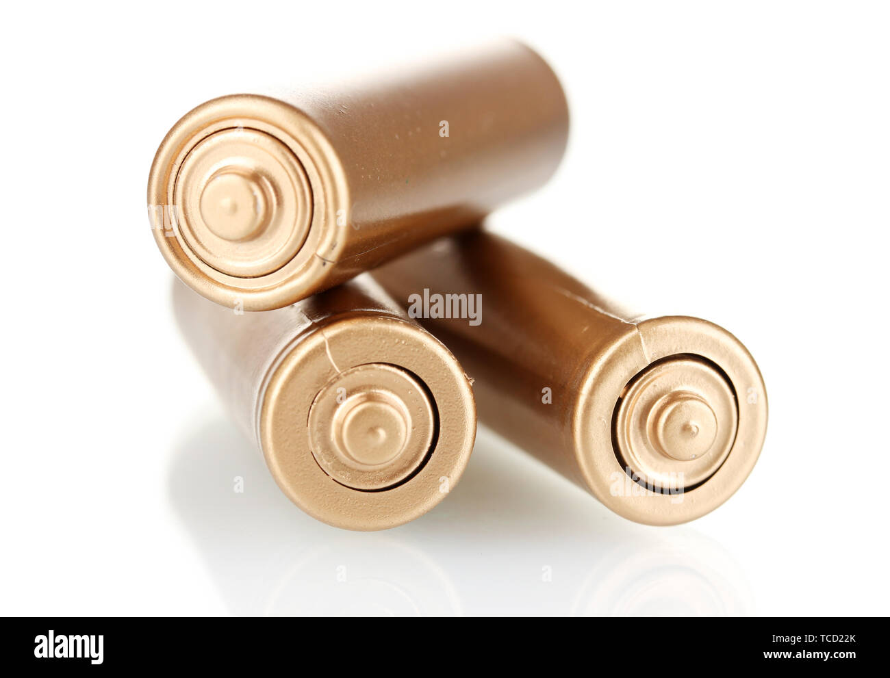 three golden batteries isolated on white Stock Photo - Alamy