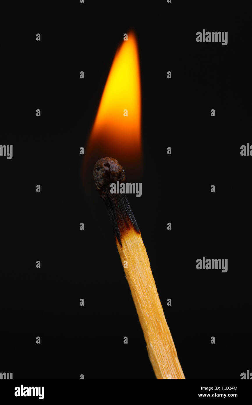 Burning match on black background Stock Photo - Alamy