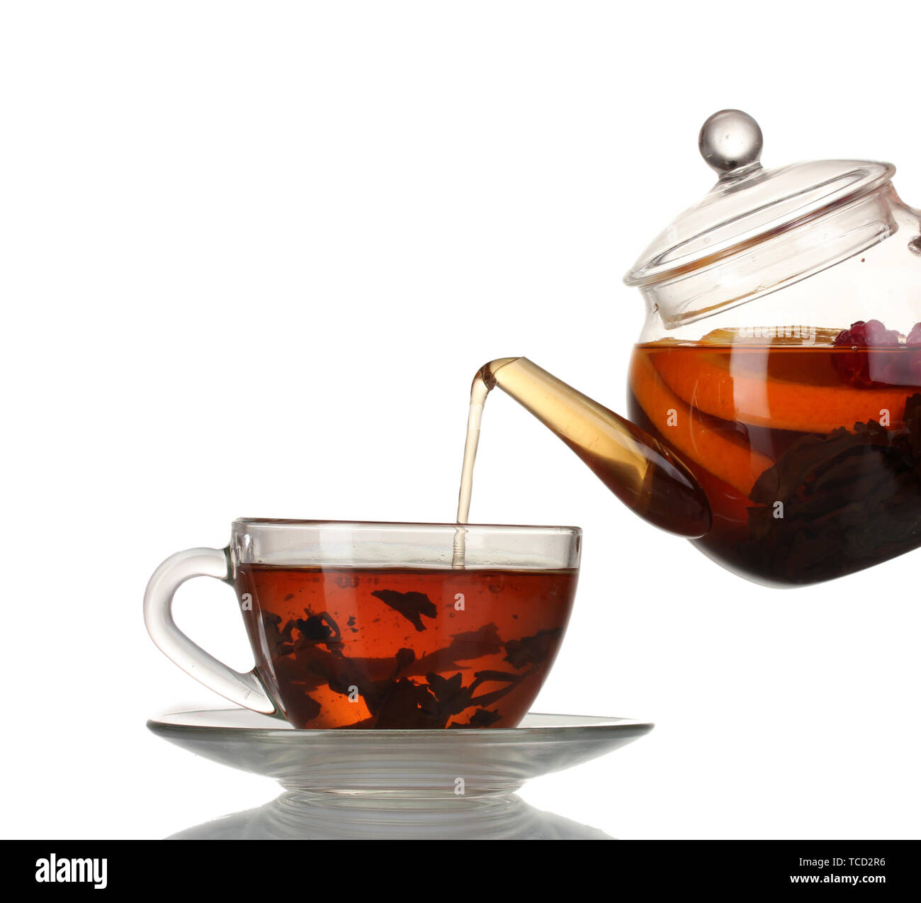 Glass teapot pouring black tea into cup isolated on white Stock Photo ...