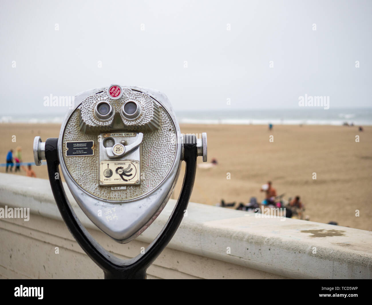 Tower viewer telescope and binoculars looking off to ocean and beach on ...