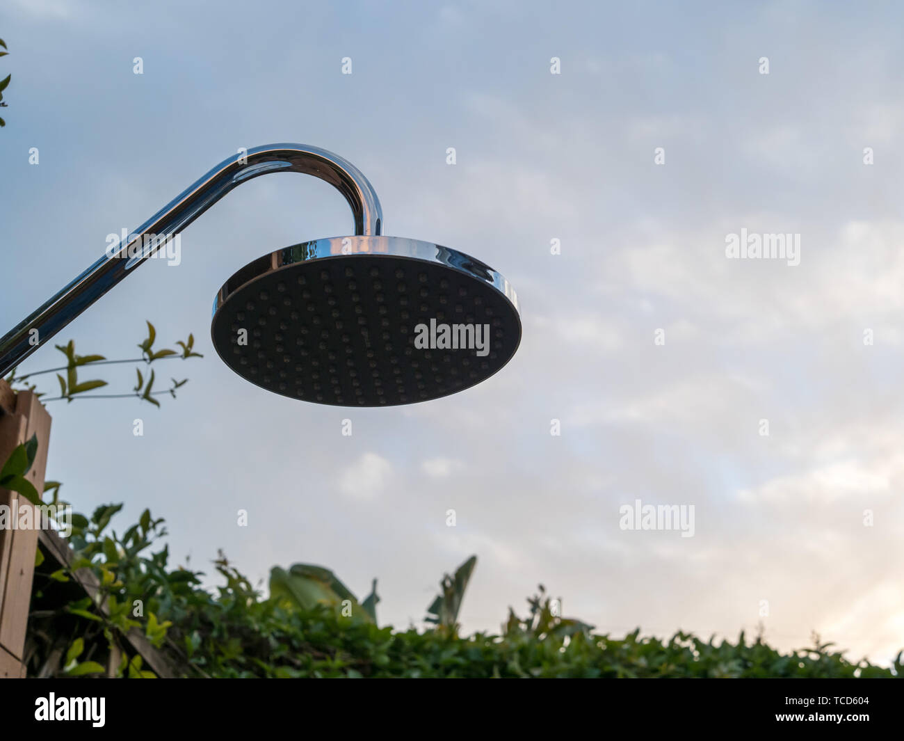 Waterfall showerhead outside in evening sky in outdoor bath area Stock ...