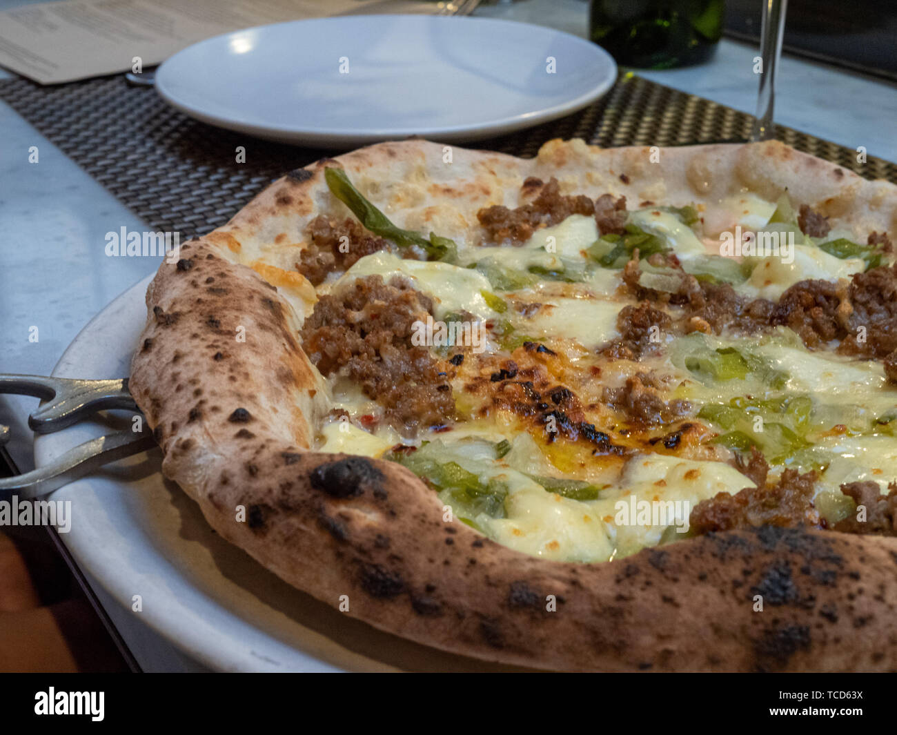 Sausage pizza with high crust, uncut and ready to serve Stock Photo - Alamy