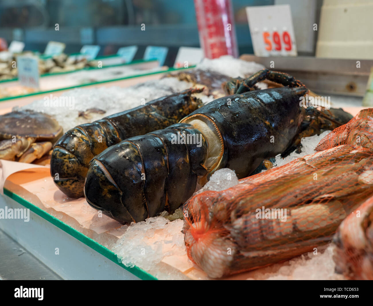 Raw, dead lobster sitting on ice in grocery store seafood section for ...