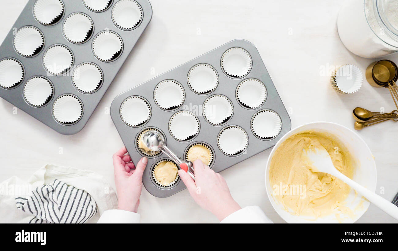 Flat lay. Step by step. Scooping cupcake batter into cupcake liners to ...
