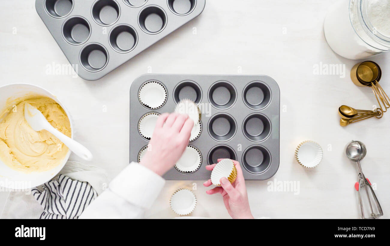 Flat lay. Step by step. Placing cupcake liners onto the cupcake pan to ...