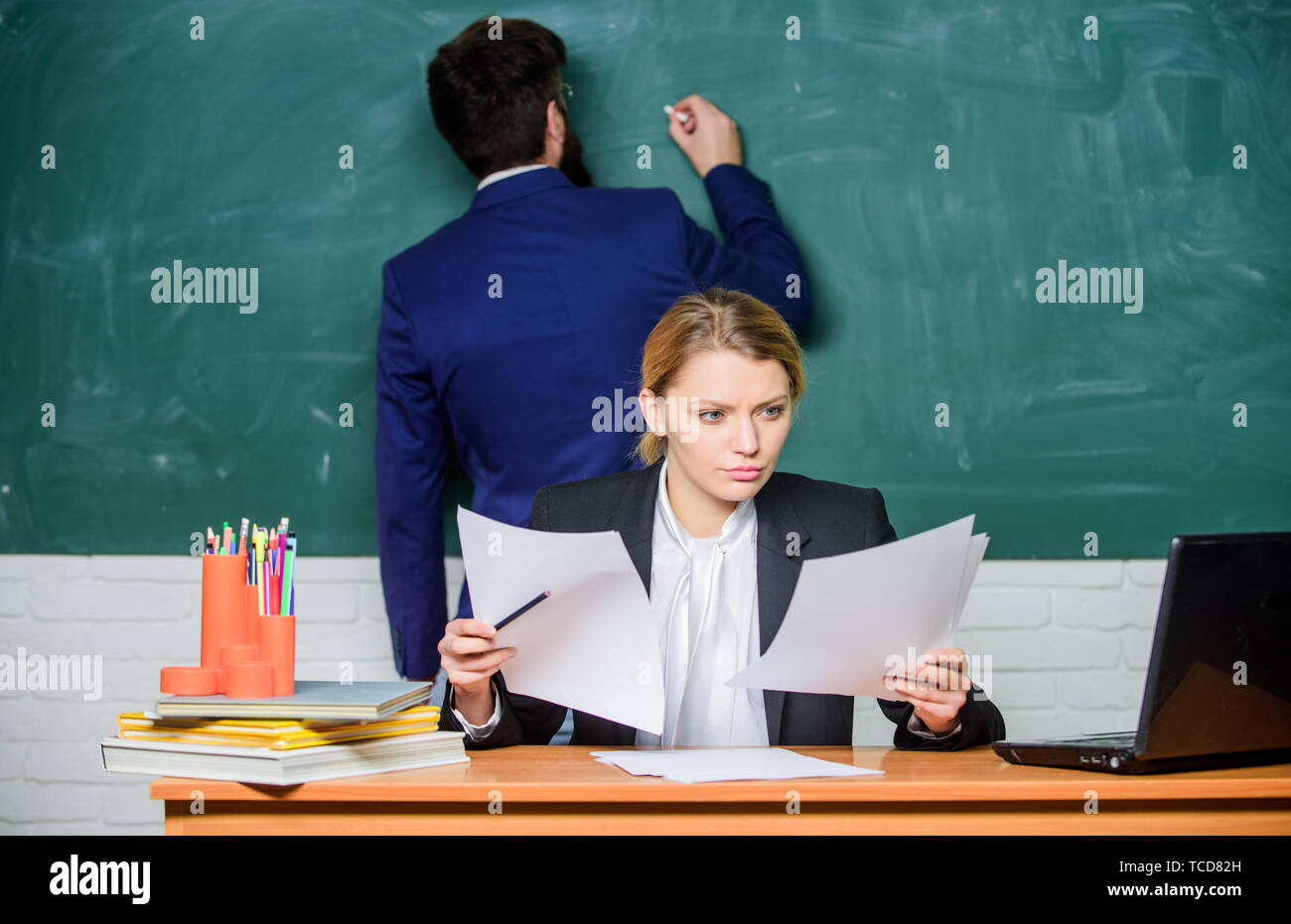 Write down your task. Teachers working in pairs school classroom ...