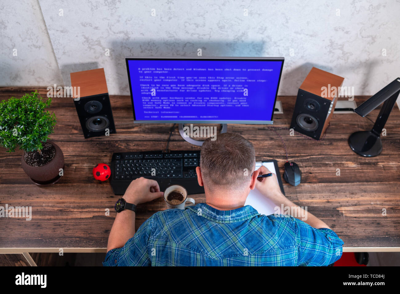 Businessman taking notes from his computer screen writing on a ...