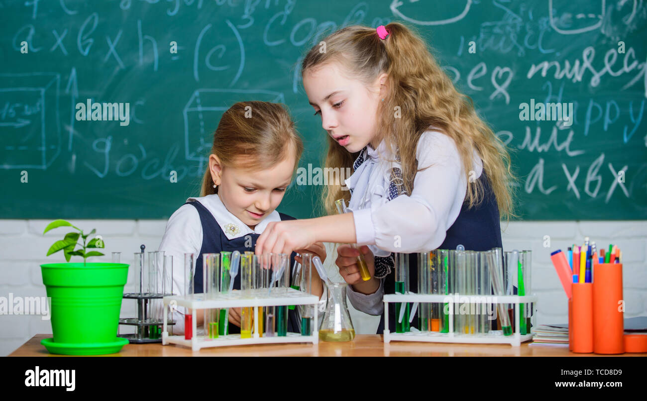 School laboratory partners. Kids busy with experiment. Test tubes with ...