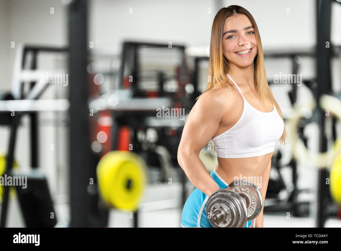 Sporty woman with dumbbell Stock Photo - Alamy
