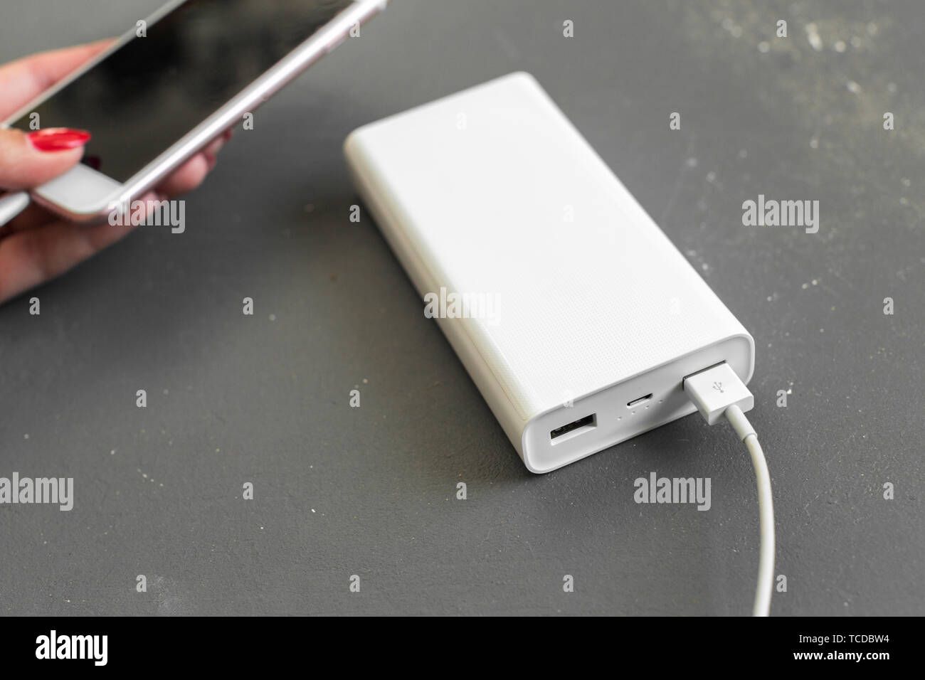 Smartphone charging with power bank Stock Photo - Alamy