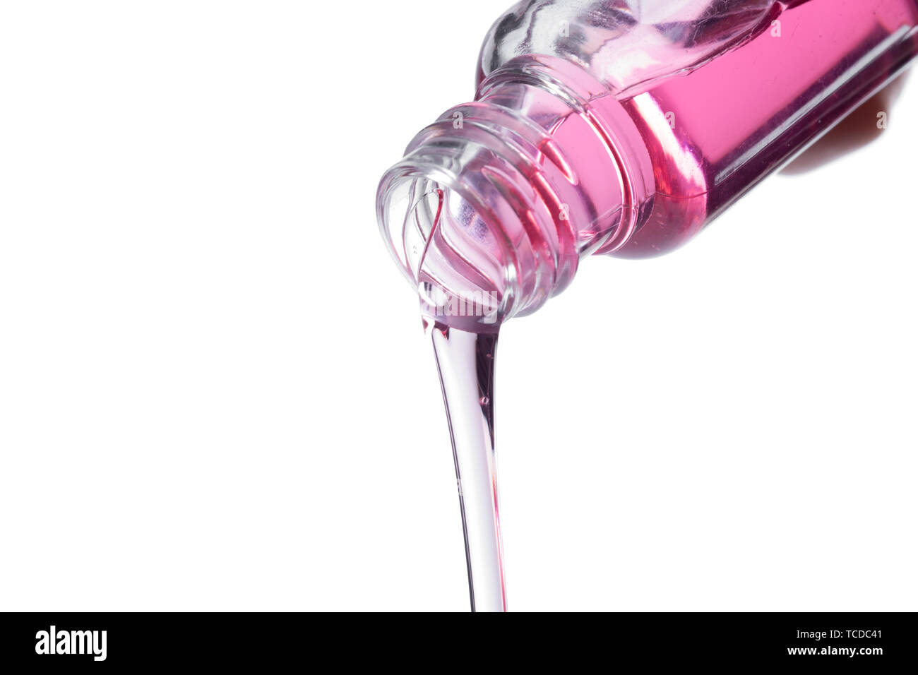 Cosmetic liquid pouring from bottle isolated on white background Stock ...