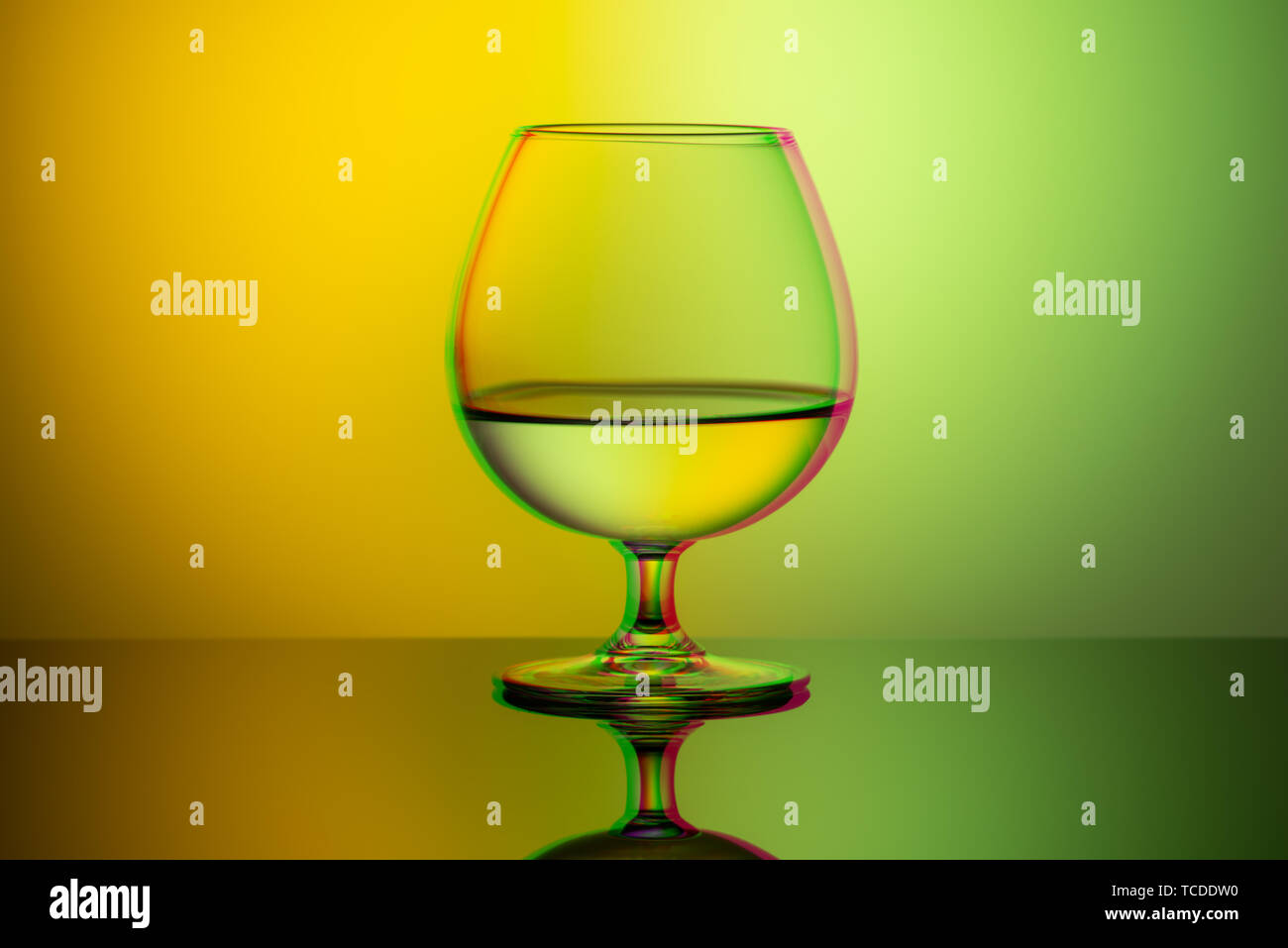 Art glitch effect, glass with water on bright multi-colored background ...