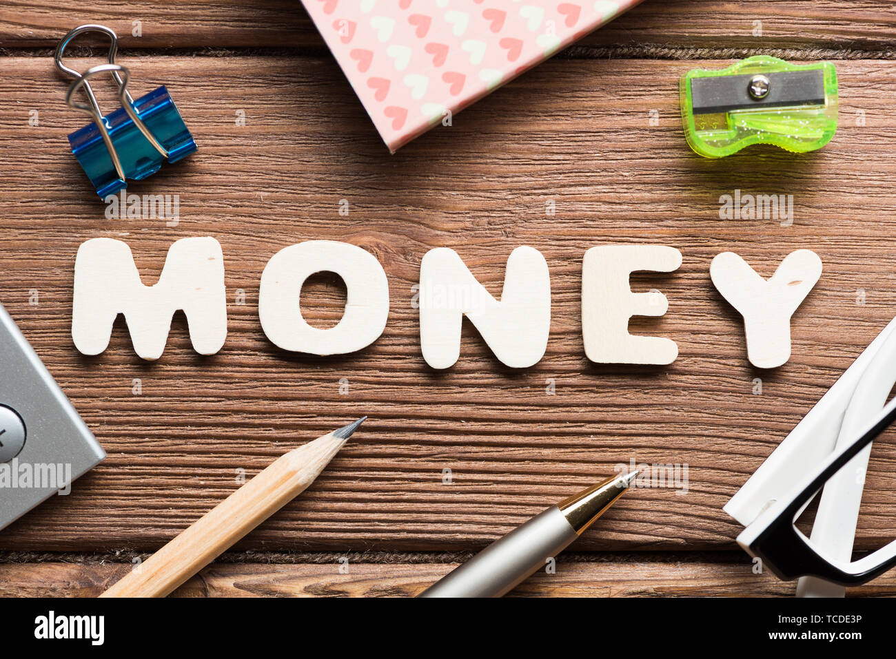 Money word on wooden table and office stationary around Stock Photo - Alamy
