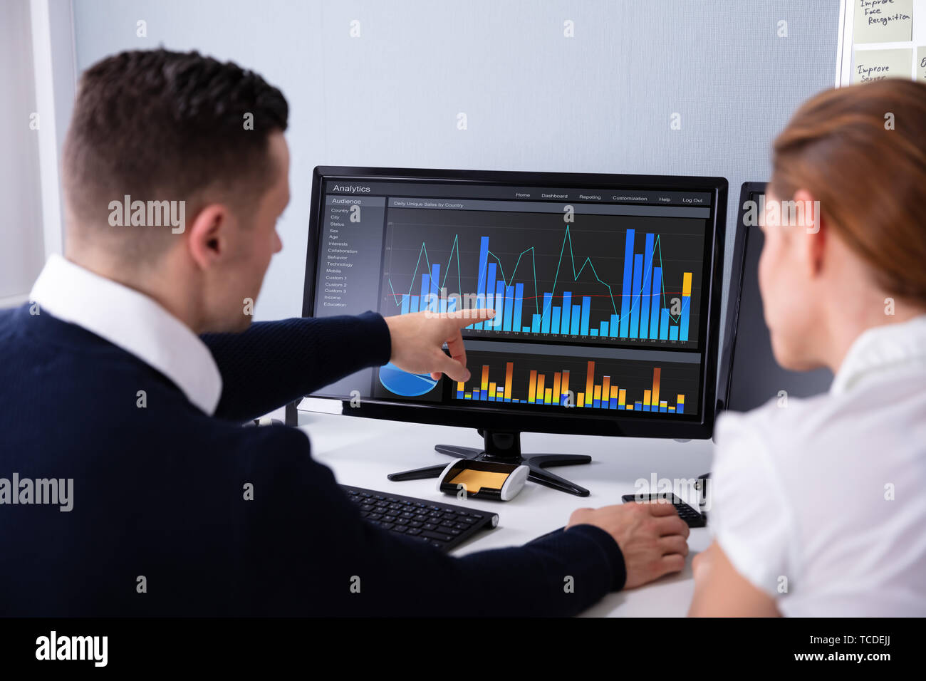 Two businesspeople examining graph hi-res stock photography and images ...