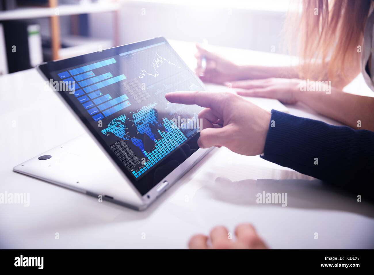Close-up Businessman's Hand Pointing Bar Graph On Laptop Screen Over ...