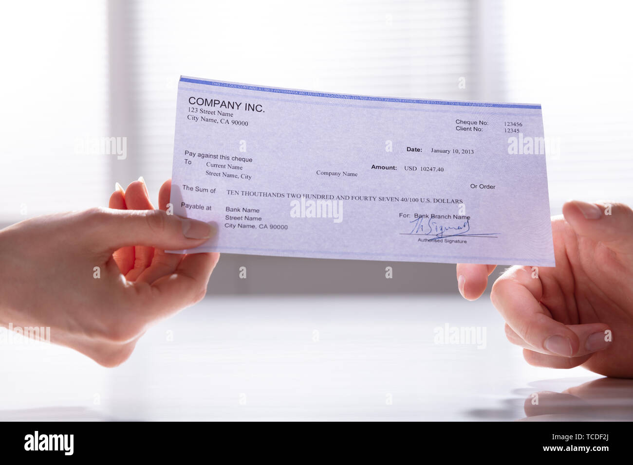 Close-up Of Woman's Hand Holding Cheque And Giving To Man Stock Photo ...