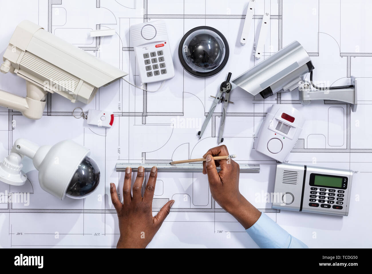 Close-up Of An Architect's Hand Drawing Blueprint Near Security ...
