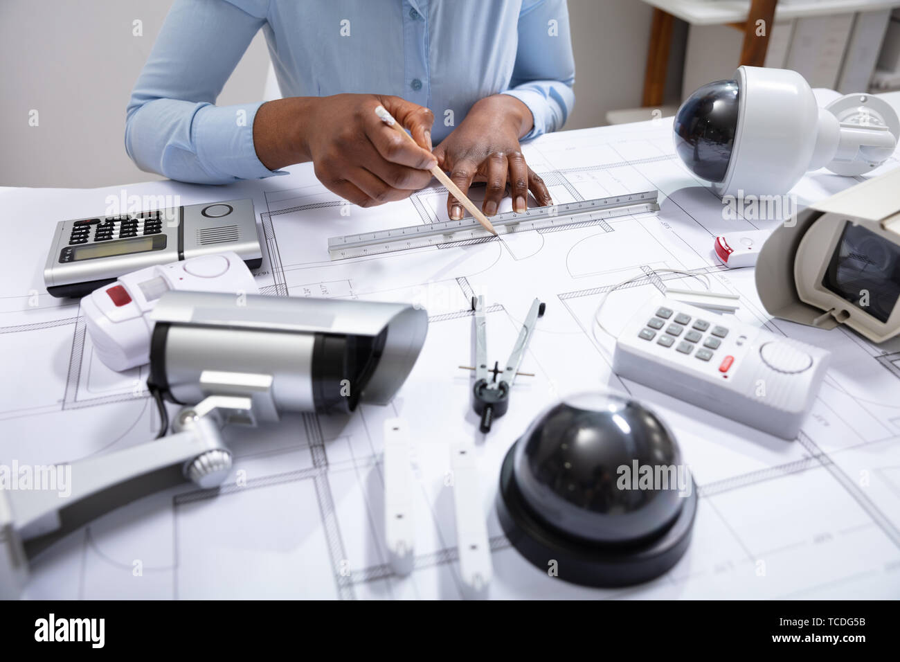 Architecture Drawing Blueprint With Various Security Equipment On Desk ...