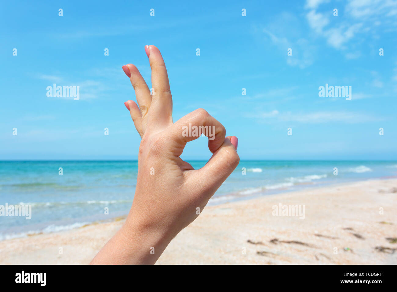 hand sign over blue sea and sky background, summer travel, holiday ...