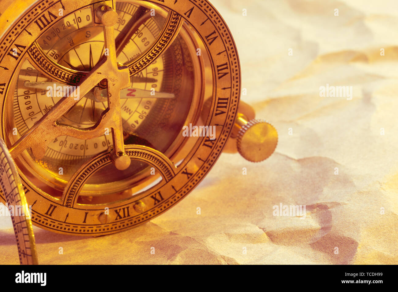 antique compass on vintage paper background Stock Photo - Alamy