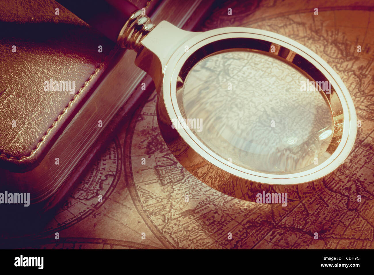 Old map with an magnifying glass Stock Photo - Alamy
