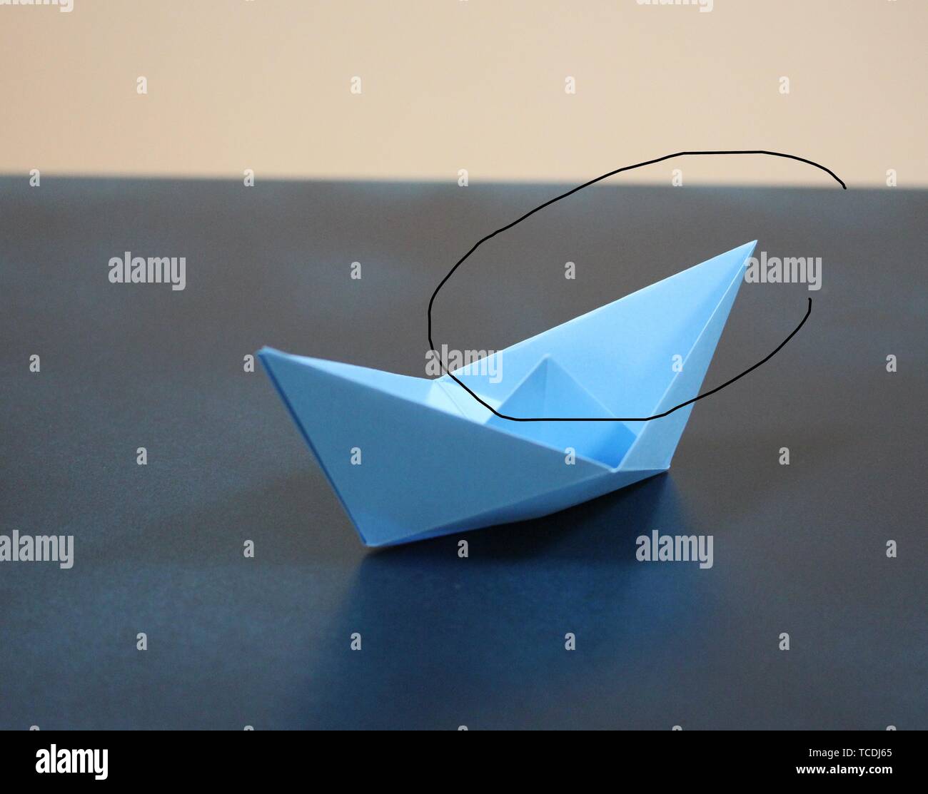 a blue paper ship Stock Photo - Alamy