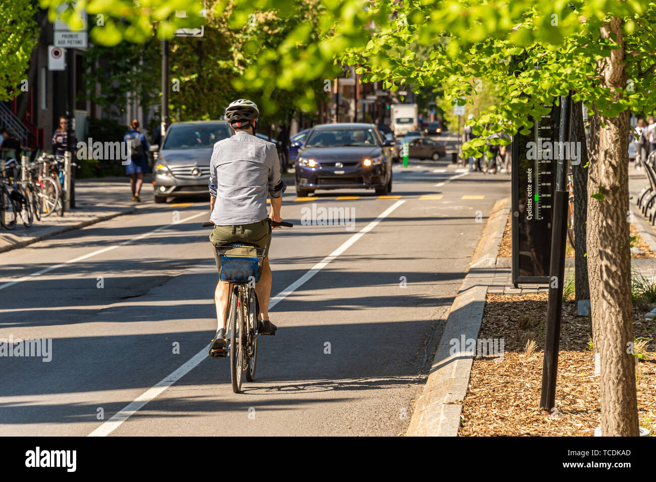 Montreal, Canada - 6 June 2019: A man is riding a bike on a cycle path ...
