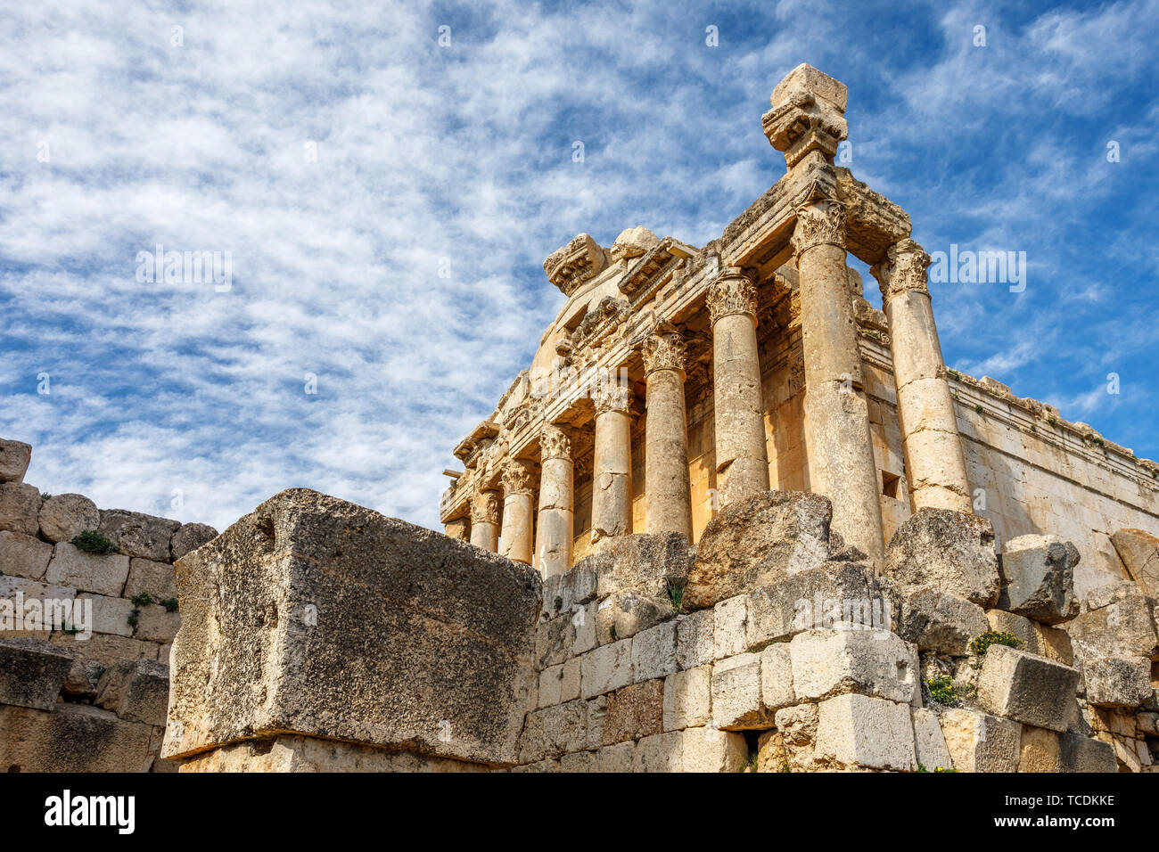 Columns of ancient Roman temple of Bacchus with surrounding ruins and ...