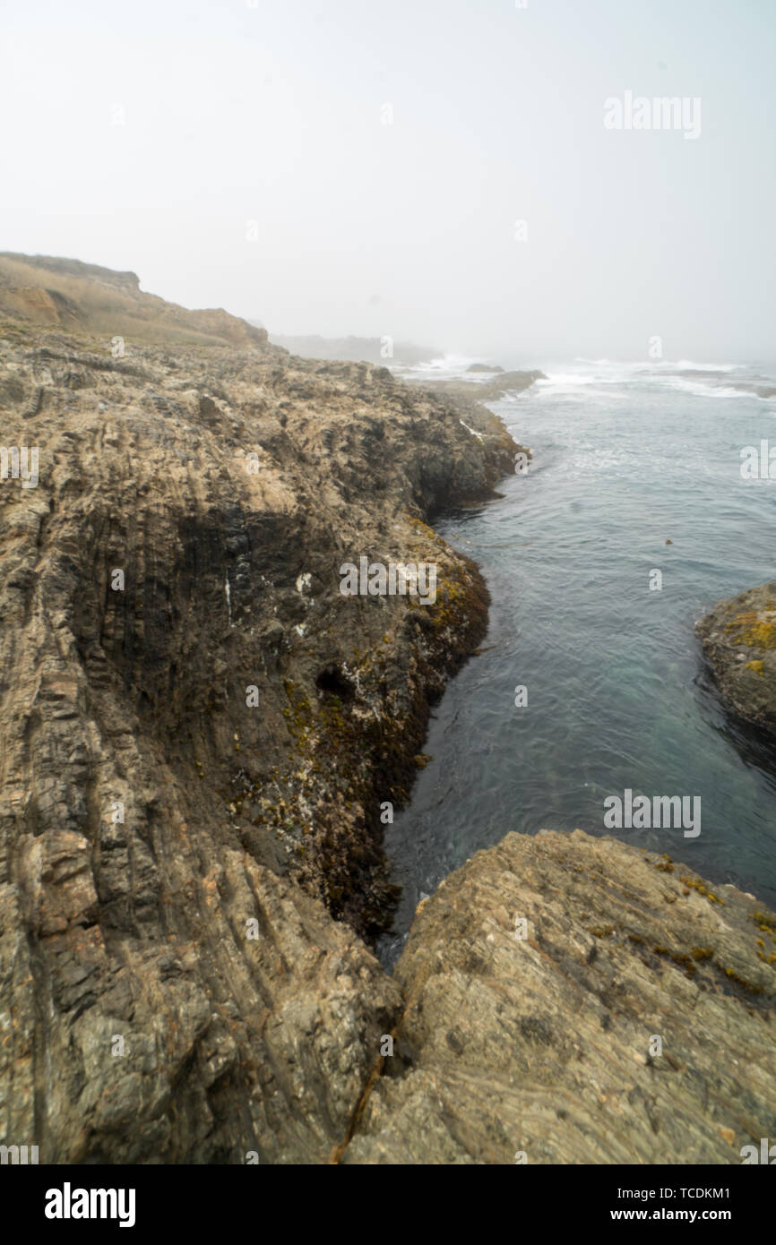 Rocky cliffs and rock islands in ocean Stock Photo - Alamy