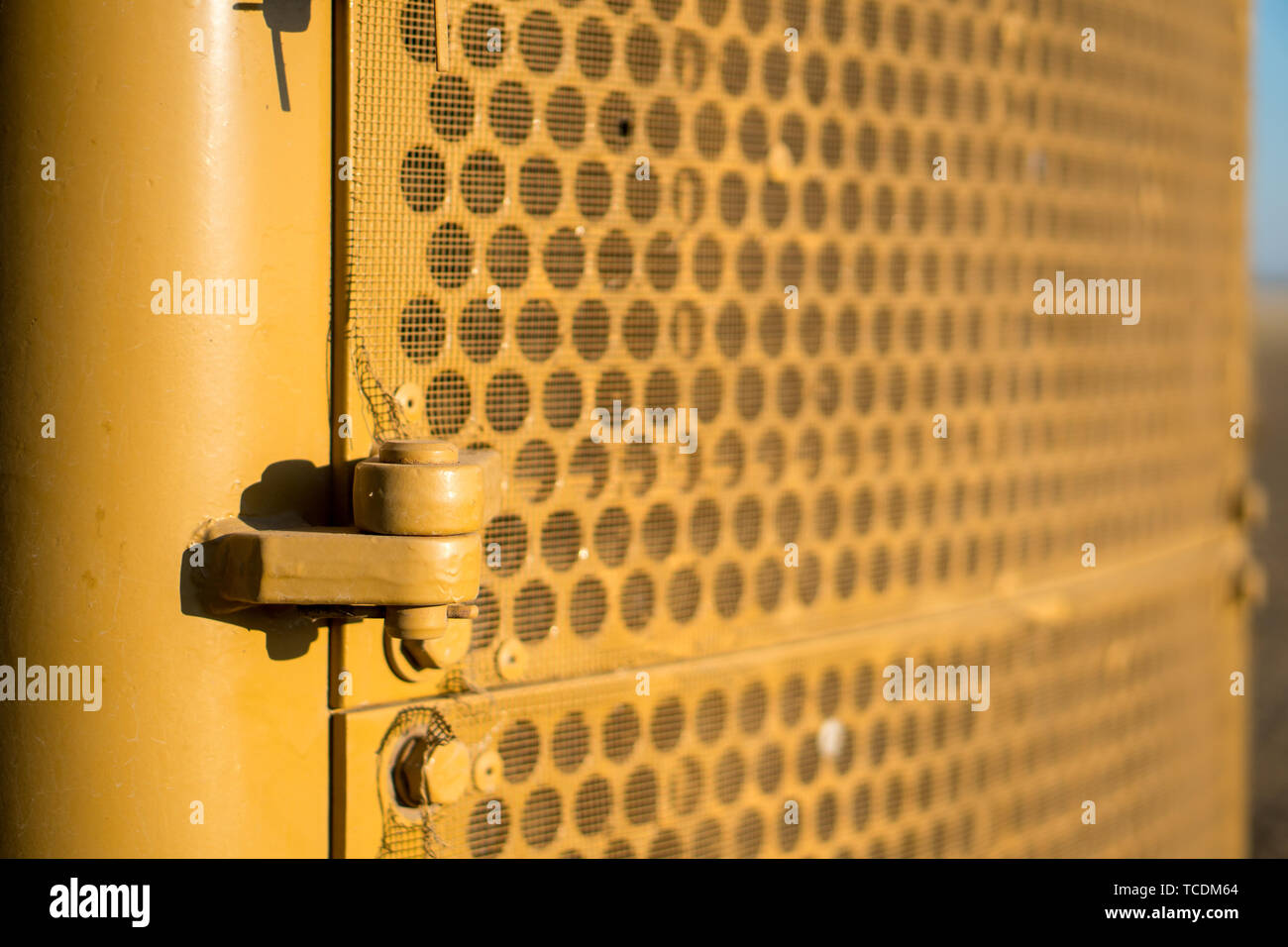 yellow Screen grate door tractor Stock Photo - Alamy