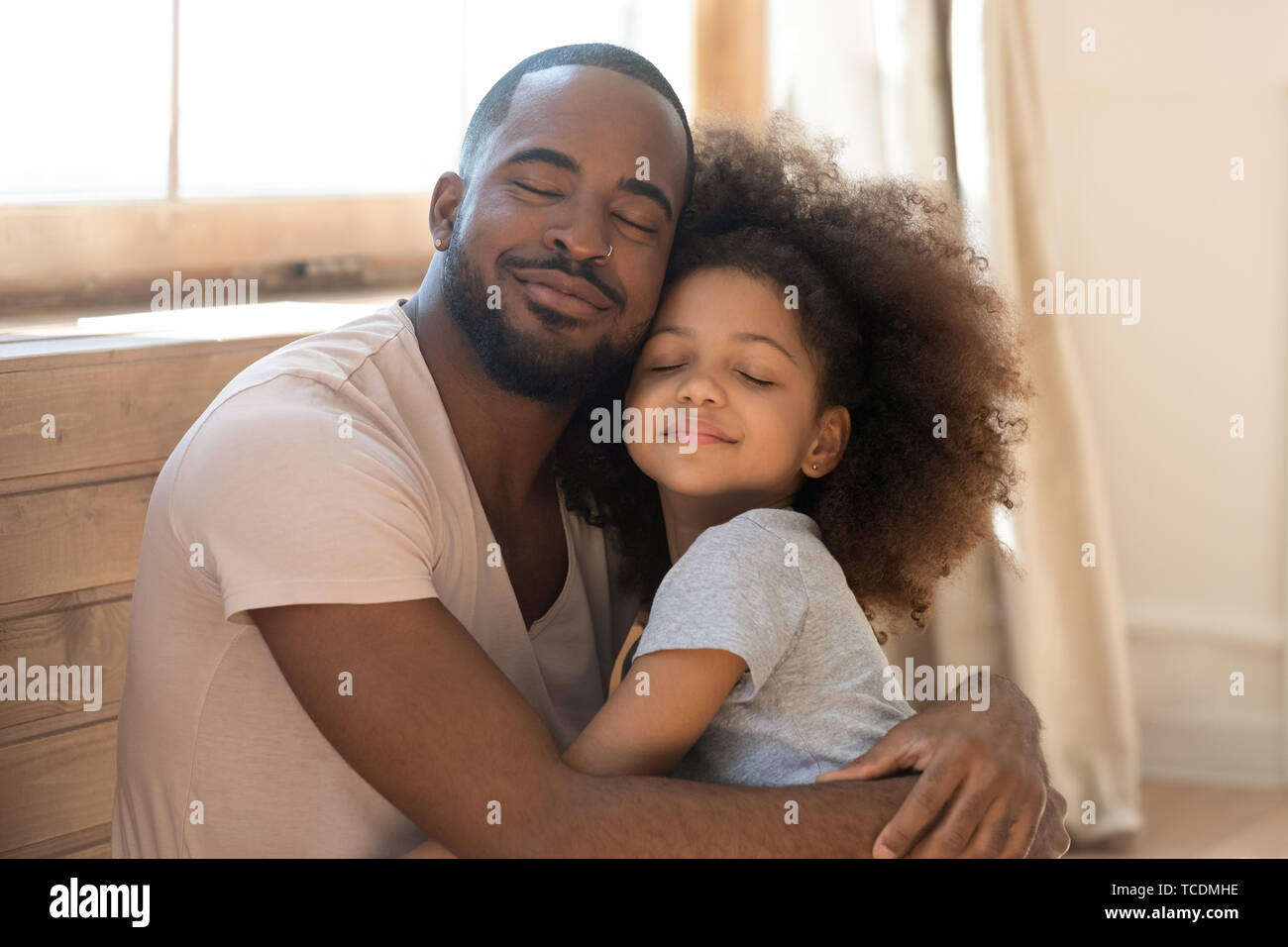 Loving african family cute funny child daughter embrace happy father ...